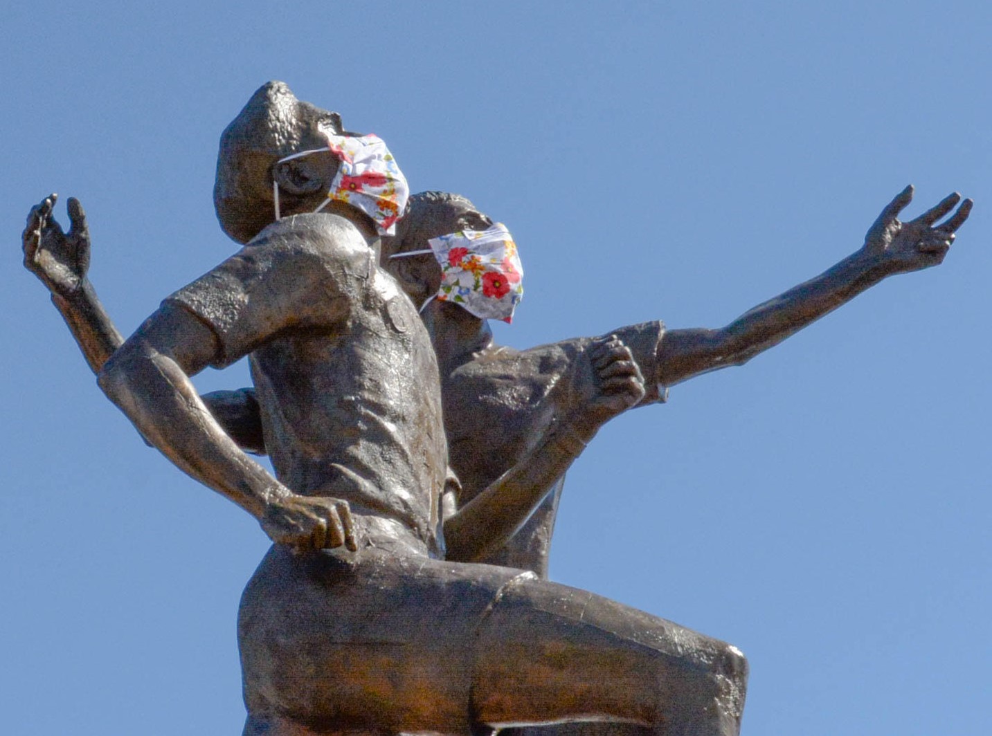 Here is why masks are being placed on statues of runners all over the ...